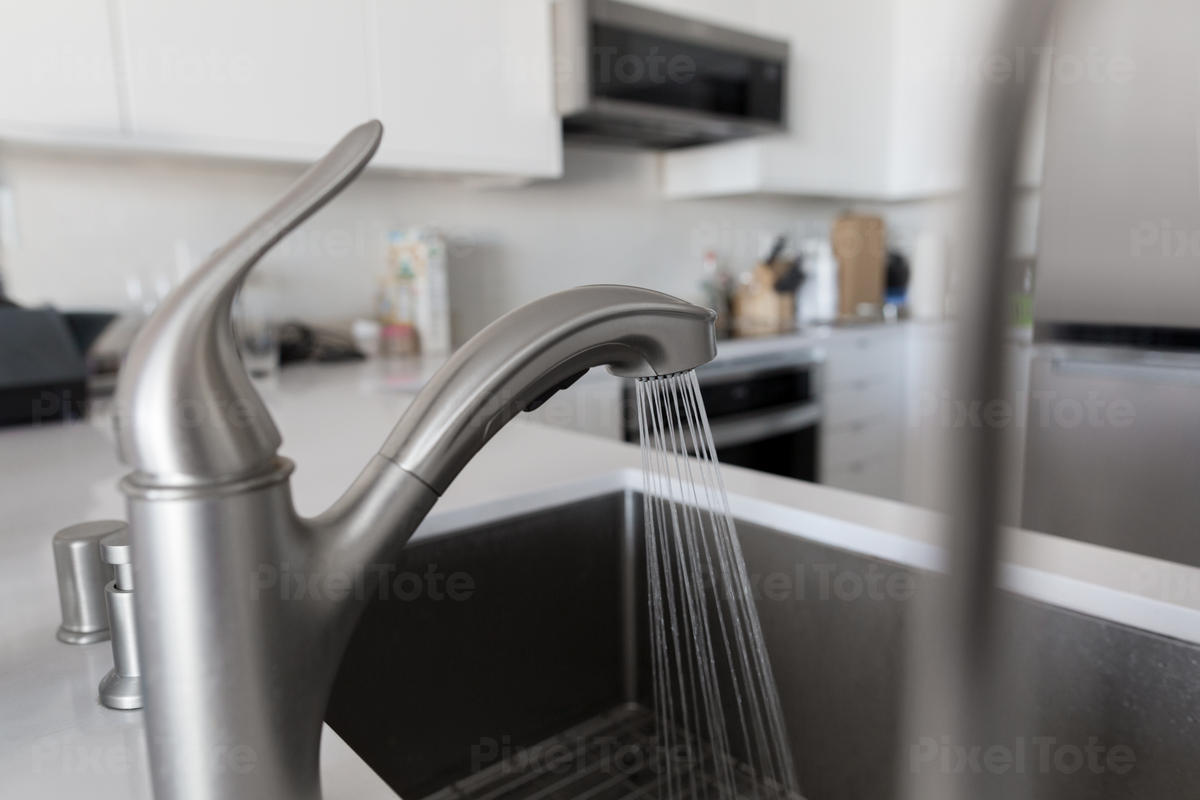 Faucet With Running Water in Stock Photo - PixelTote