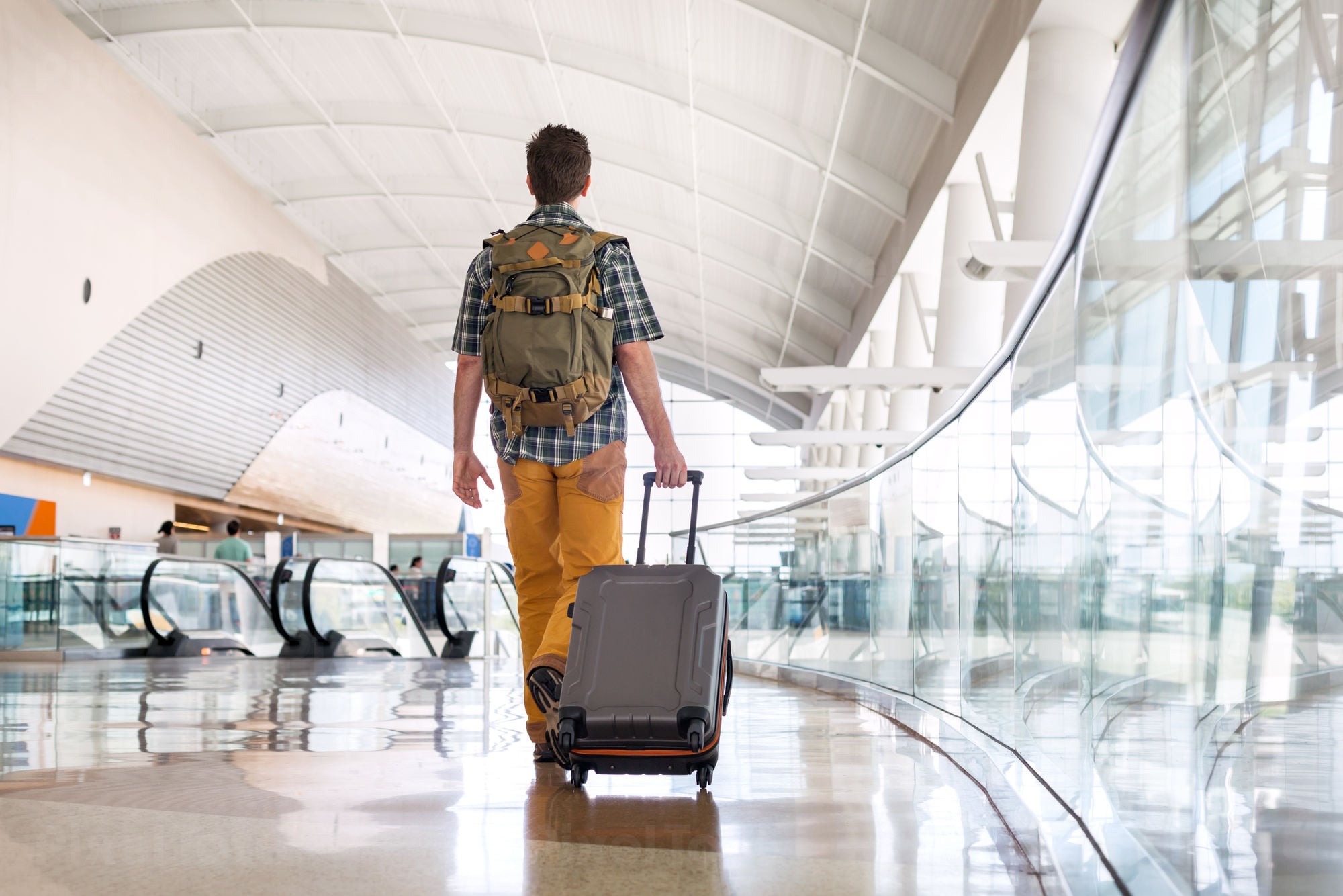 Traveler with a Backpack Pulling Stock Photo - PixelTote