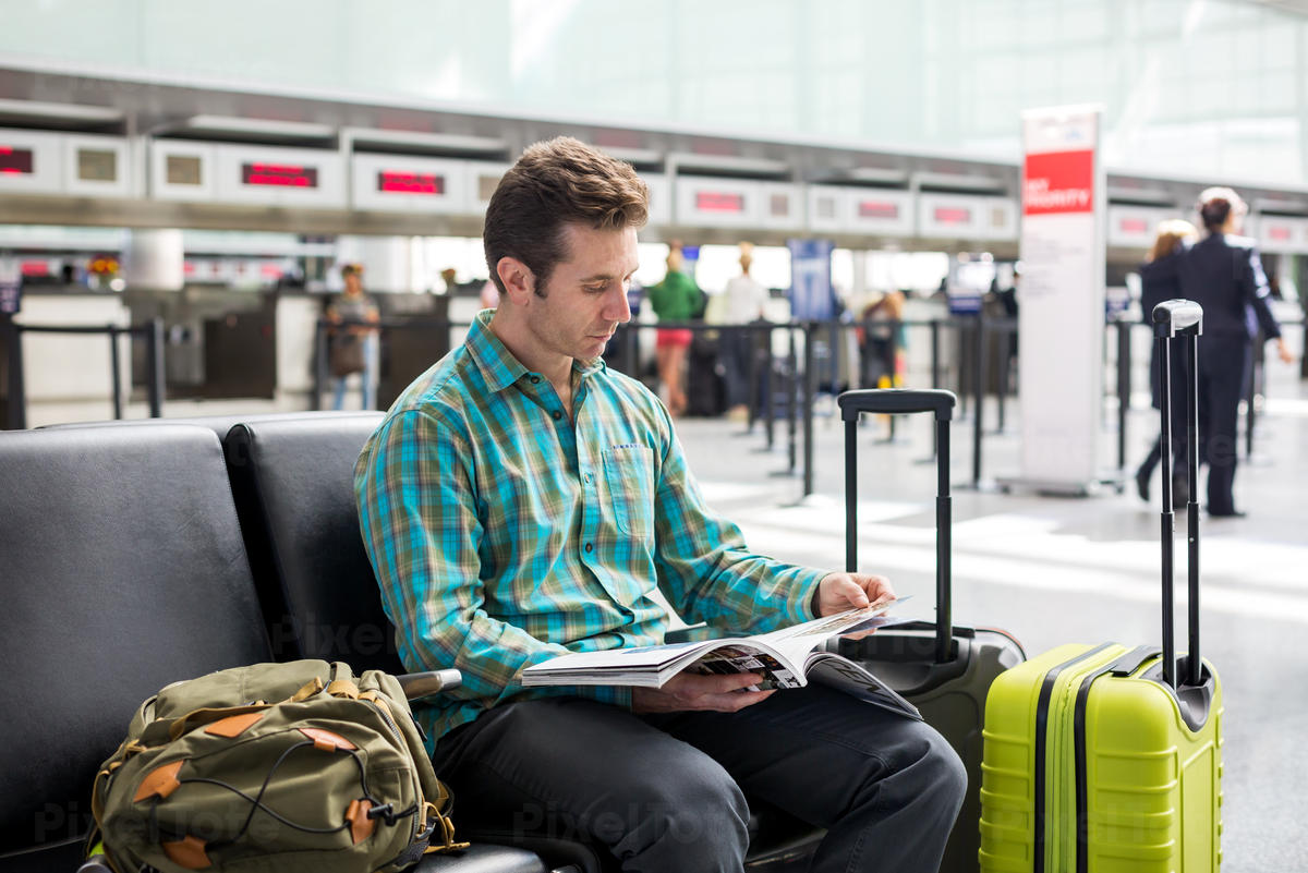 Man Reading While Waiting in Editorial Photo - PixelTote