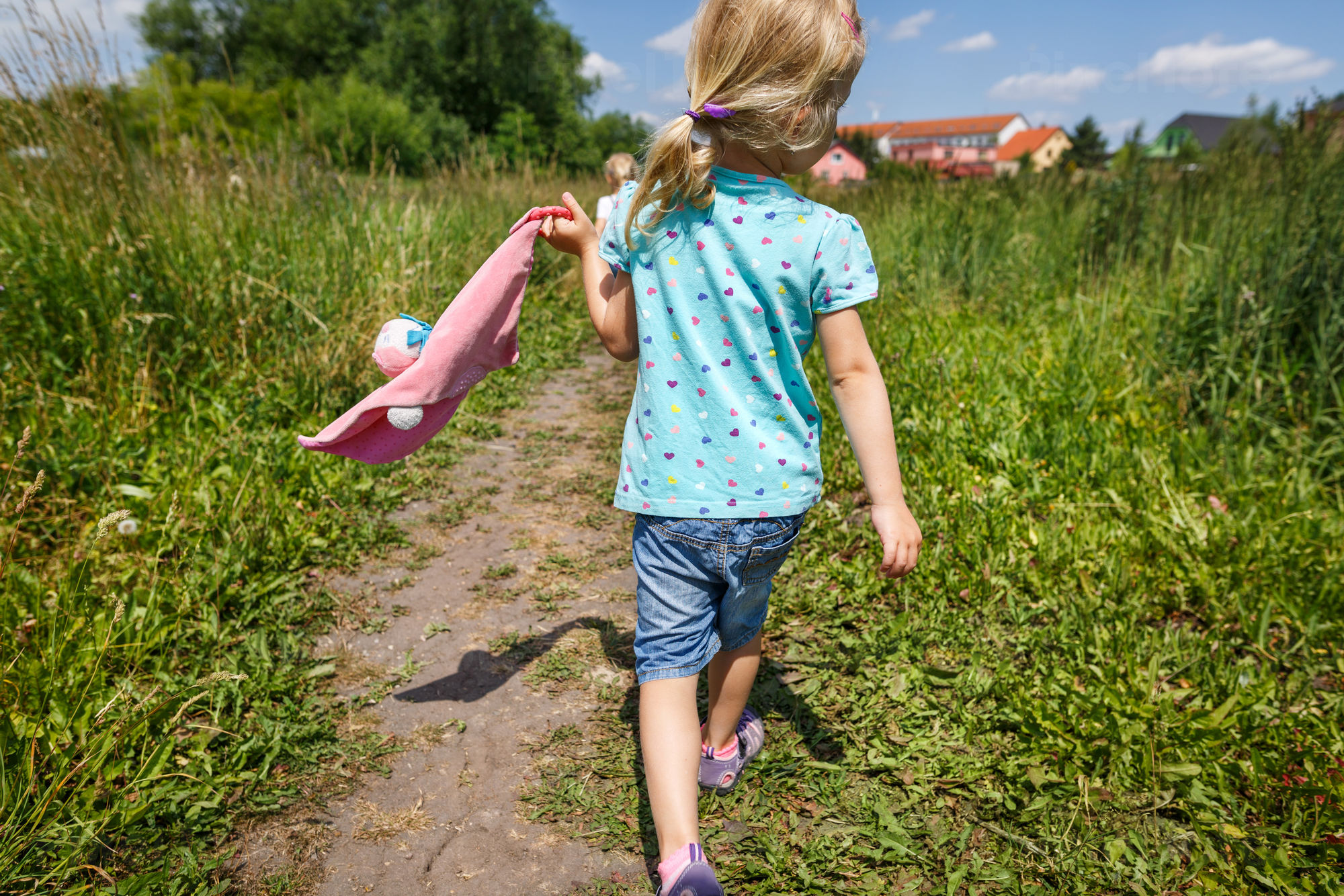 Rear View of a Little Girl Walking Stock Photo - PixelTote