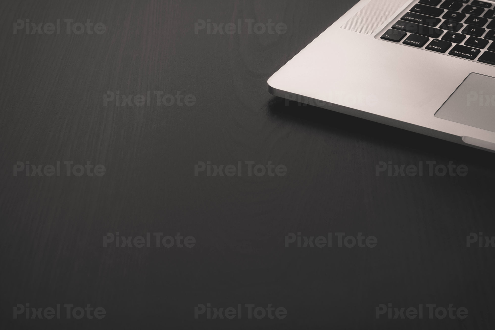View of a Laptop on a Black Table Stock Photo - PixelTote