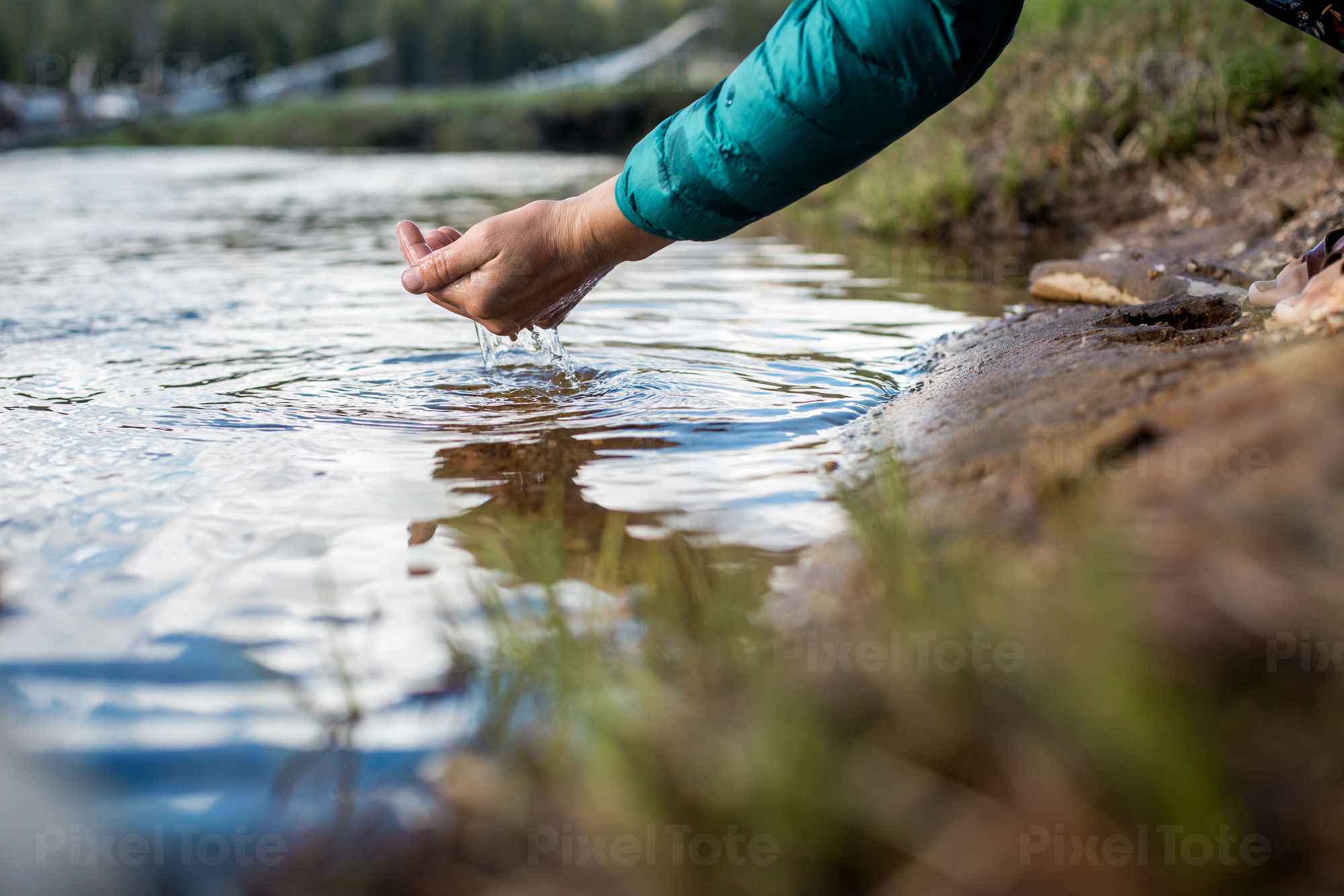 Woman Scooping Pure Water from Stock Photo - PixelTote