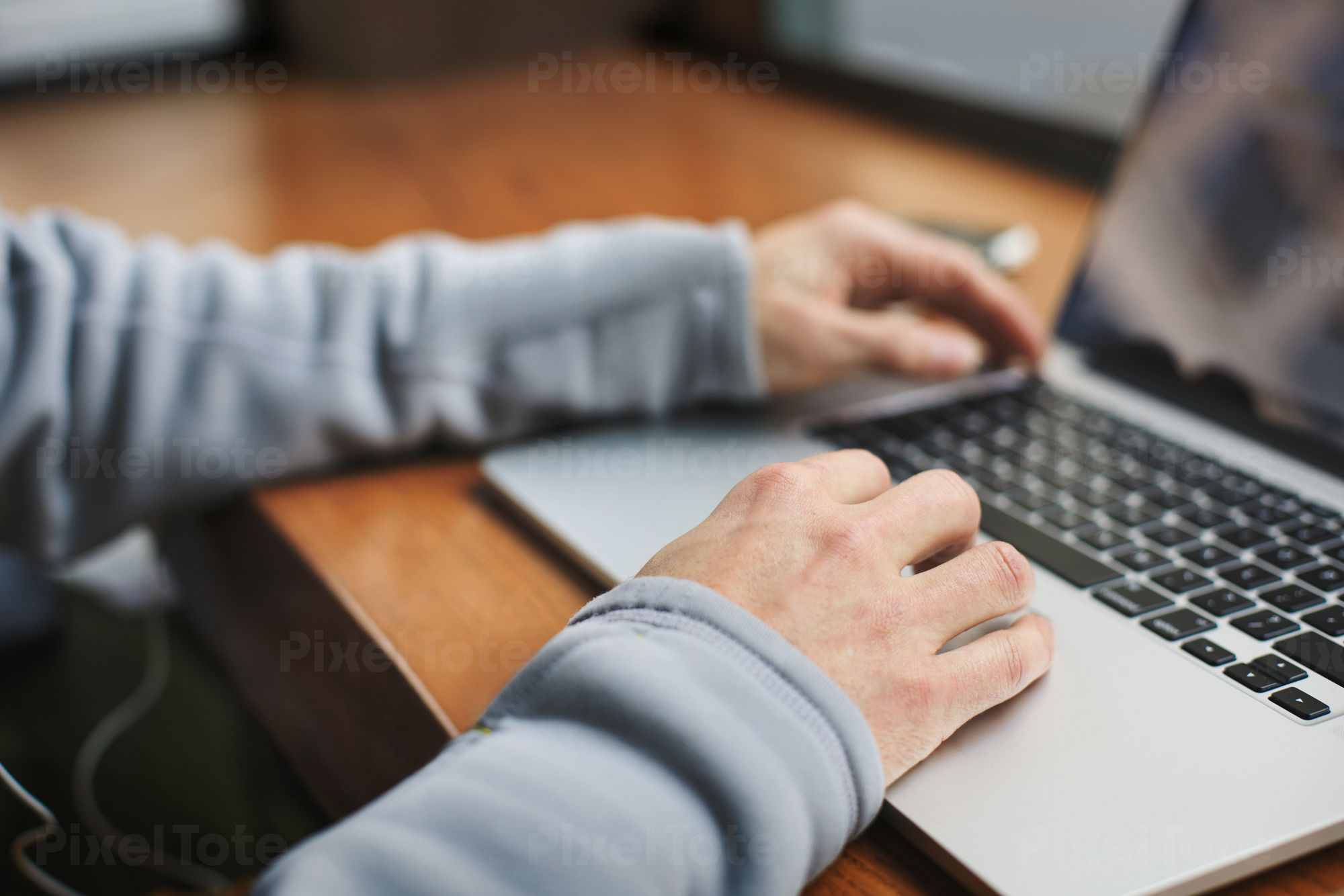 Man in a Fleece Jacket Typing Editorial Photo - PixelTote