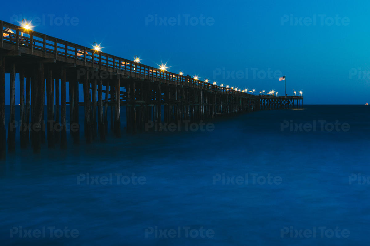 Pier Illuminated with Street Stock Photo - PixelTote