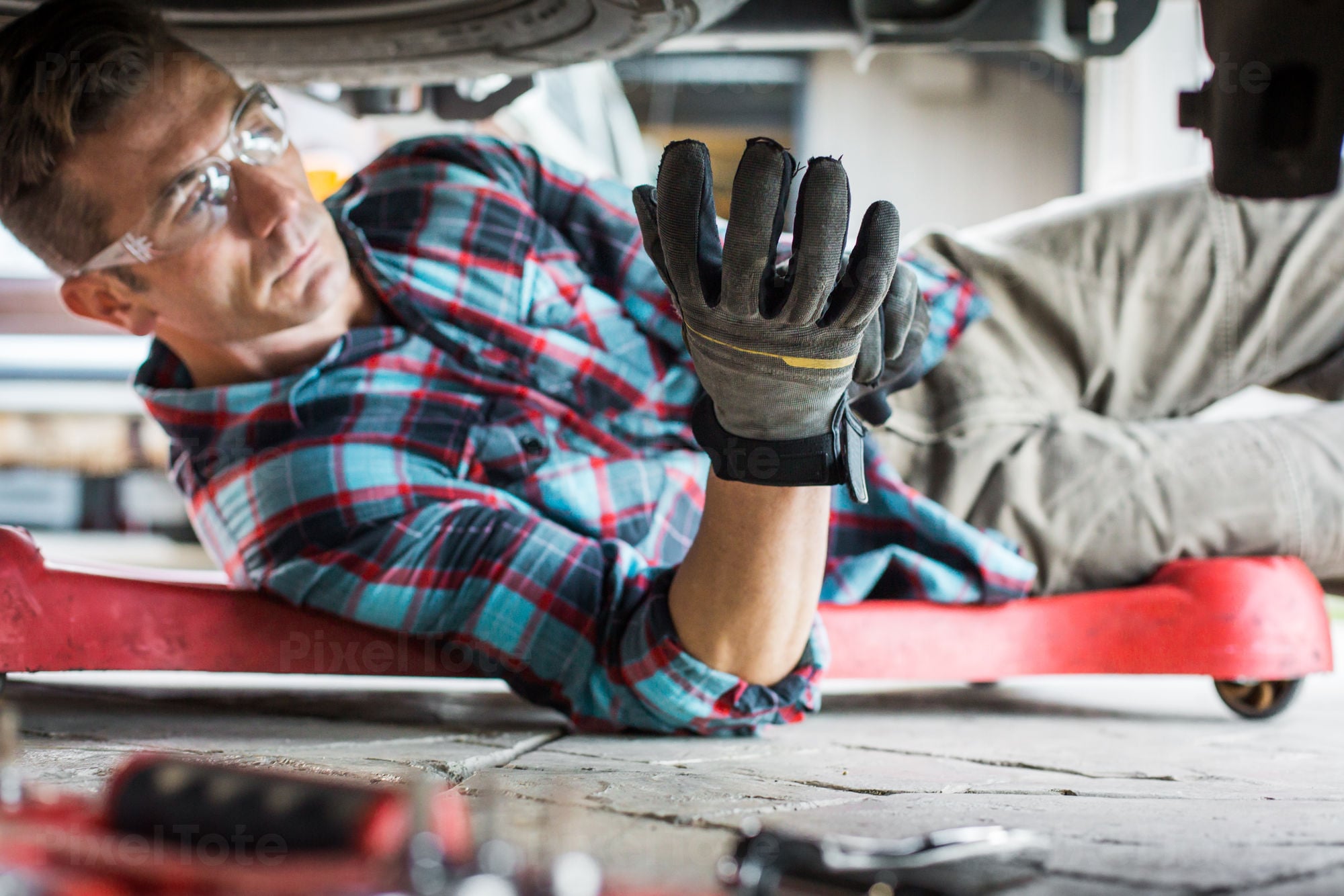 Car Mechanic Putting Protective Stock Photo - PixelTote