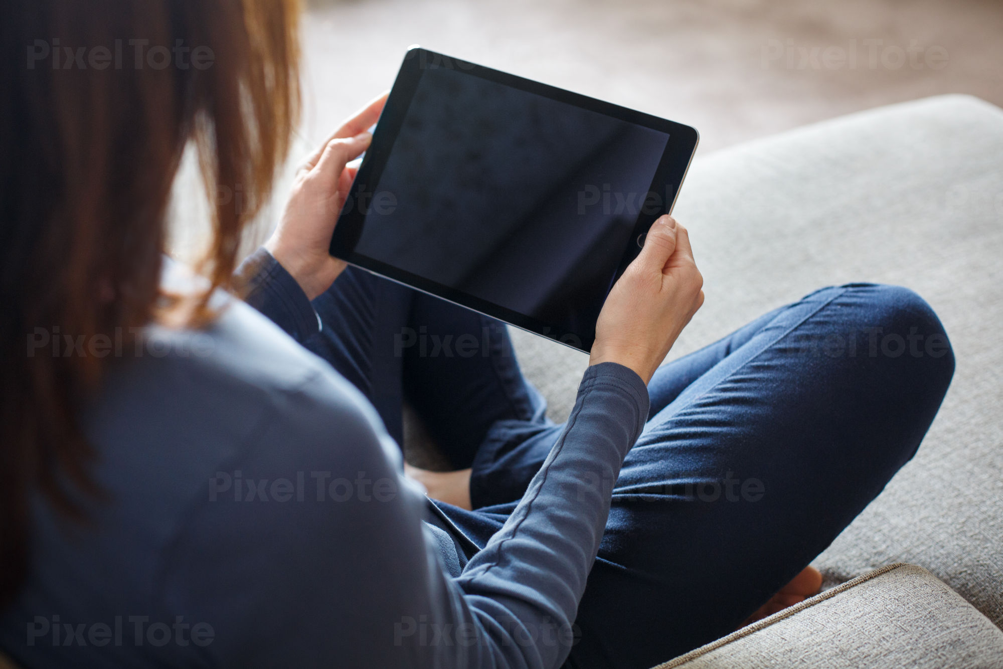 Woman Holding a Digital Tablet Stock Photo - PixelTote