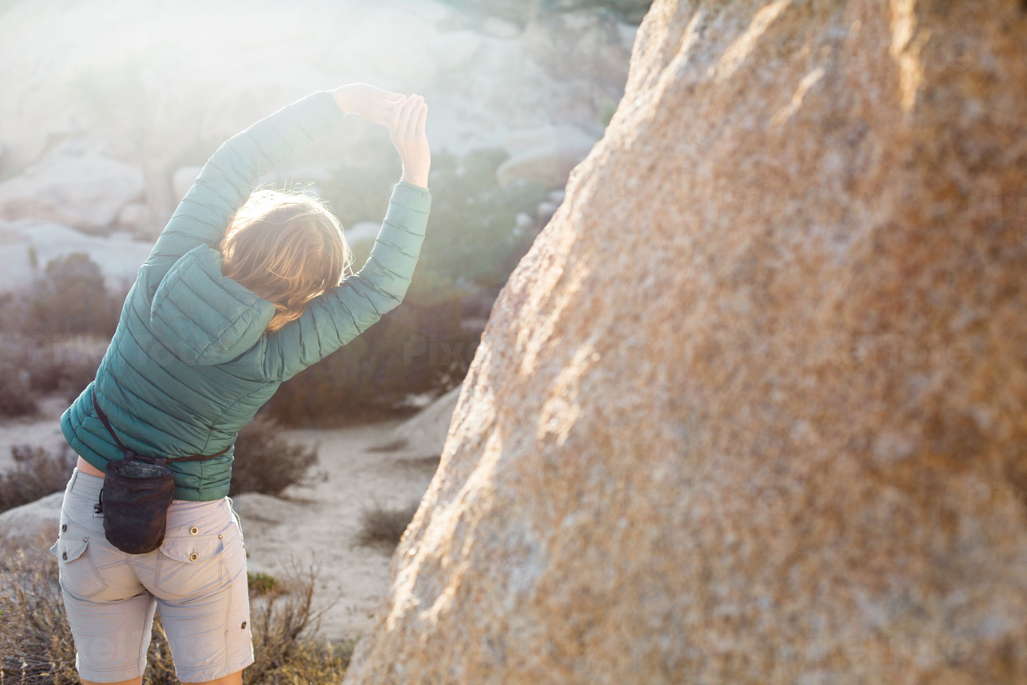 Rear View of a Woman Stretching Stock Photo - PixelTote