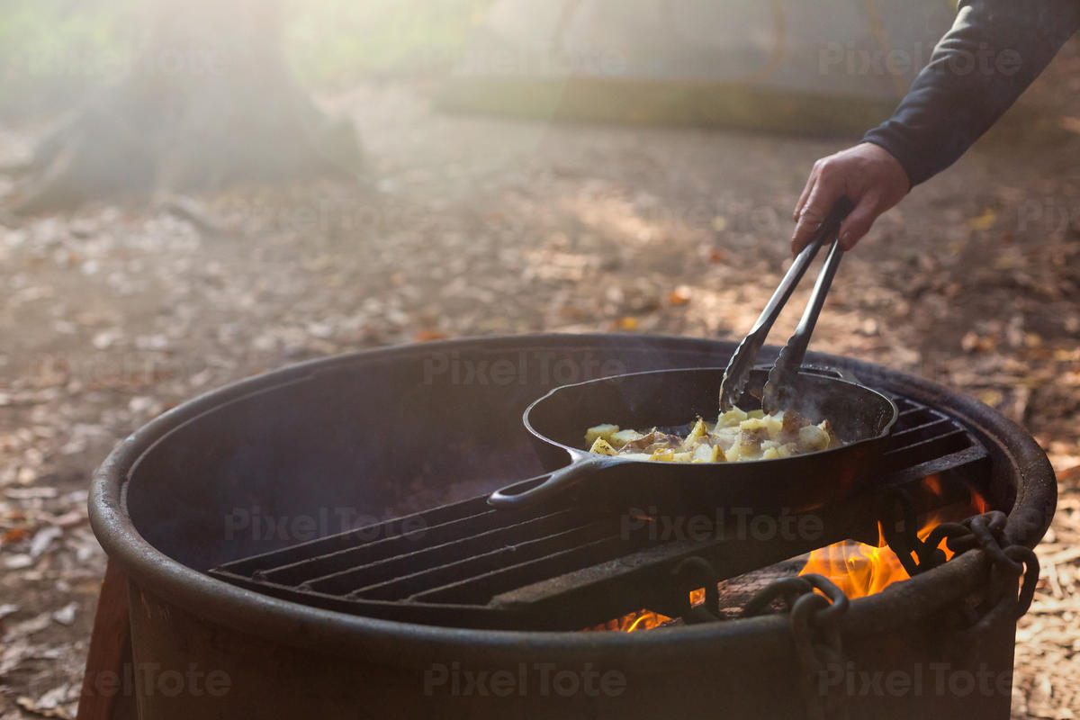 Man Using Tongs While Preparing Stock Photo - PixelTote