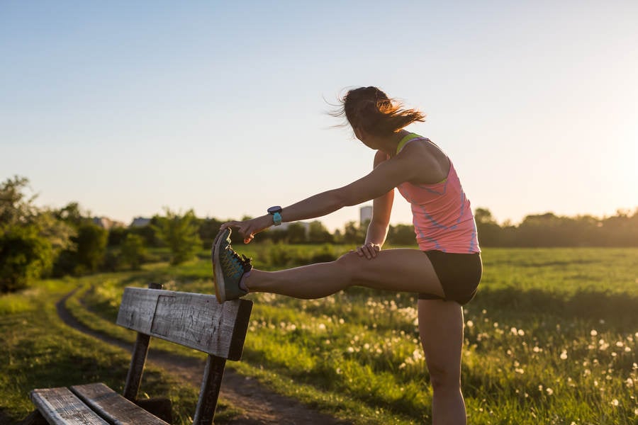 Low-Angle View of an Athletic Woman Running During Sunset Stock Photo