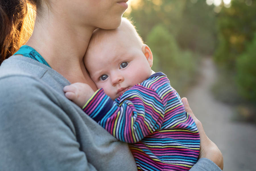 Baby Girl Snuggling with Her Stock Photo - PixelTote
