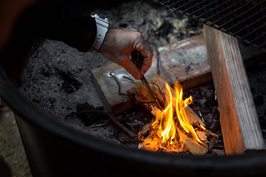 Man's Hand Starting Fire in a Stock Photo - PixelTote