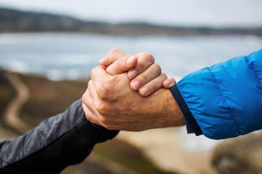 Close-Up of a Man Clasping Woman's Stock Photo - PixelTote