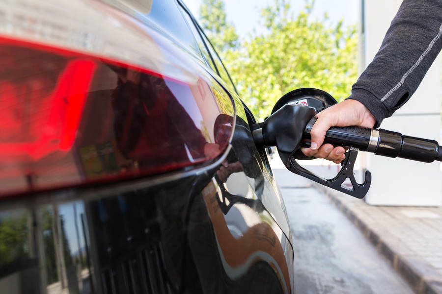 Close up of a Man Pumping Gas Stock Photo - PixelTote