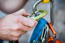 Close-Up of a Climber's Hand Crimping a Narrow Granite Hold Stock Photo