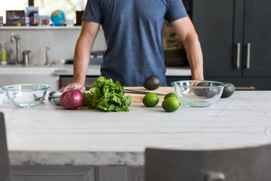Male Cook Standing Behind a Counter Stock Photo - PixelTote