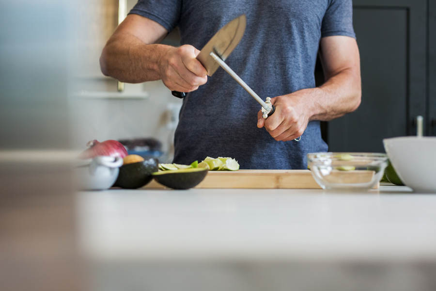 Man Standing by a Kitchen Countertop Stock Photo - PixelTote