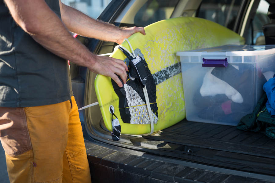 Man Unloading a Bag from a Luggage Carousel at the Airport Stock Photo