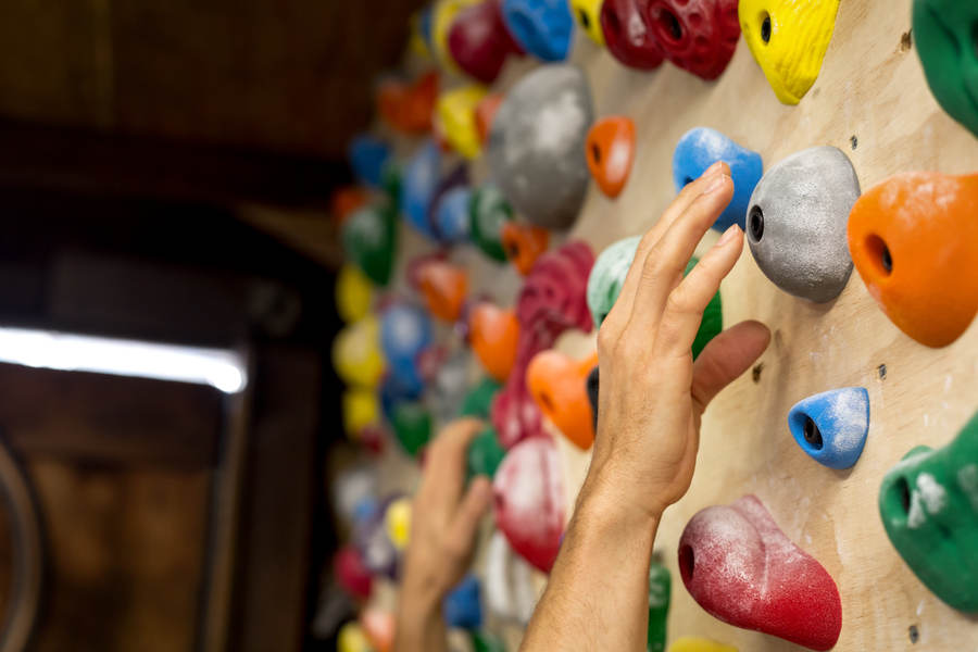 Close-Up of a Climber's Hand Crimping a Narrow Granite Hold Stock Photo